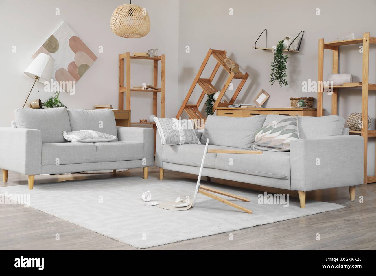 Interior of messy living room with overturned furniture after ...