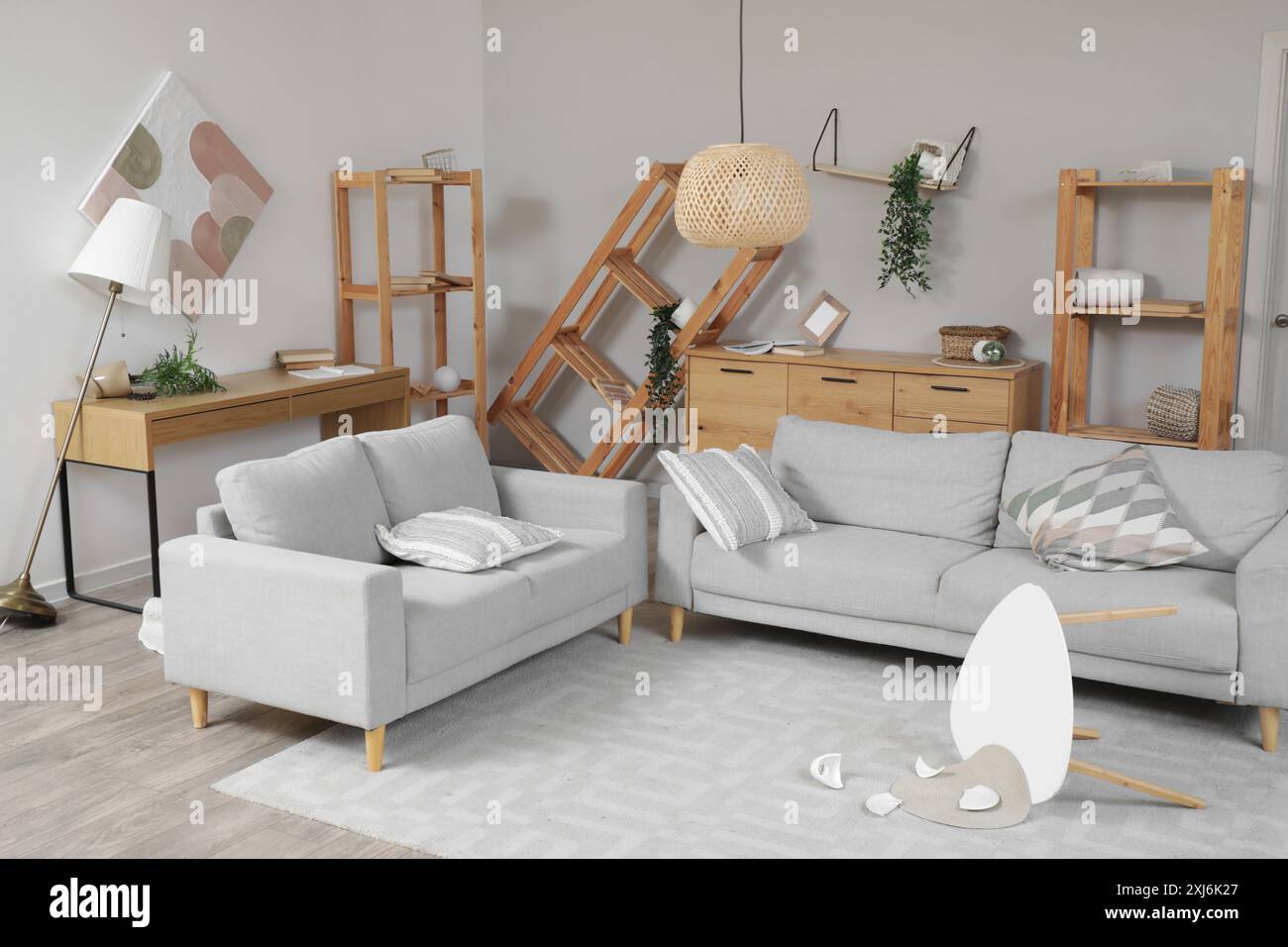 Interior of messy living room with overturned furniture after ...