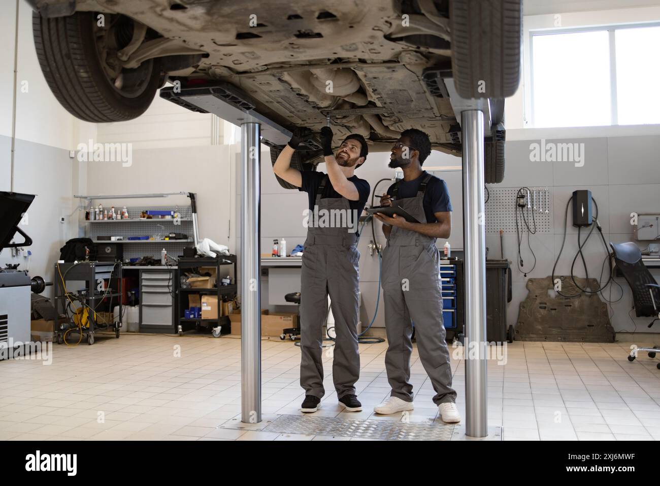Car mechanic working team fixing hi-res stock photography and images ...