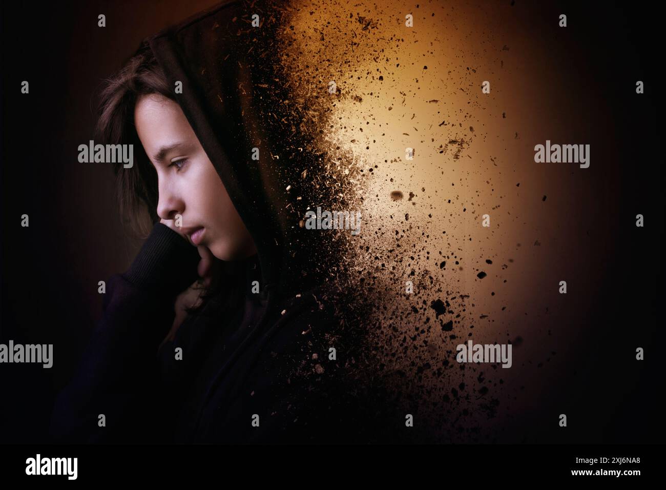 Conceptual portrait of a sad teenage girl wearing a hoodie ...