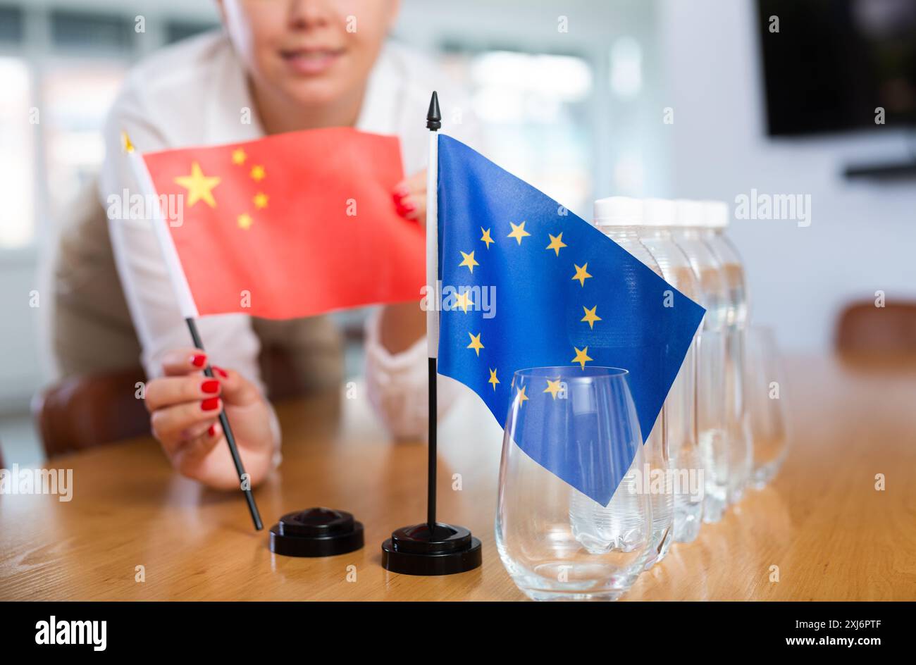 Female secretary places flags of the European Union and China flag on ...