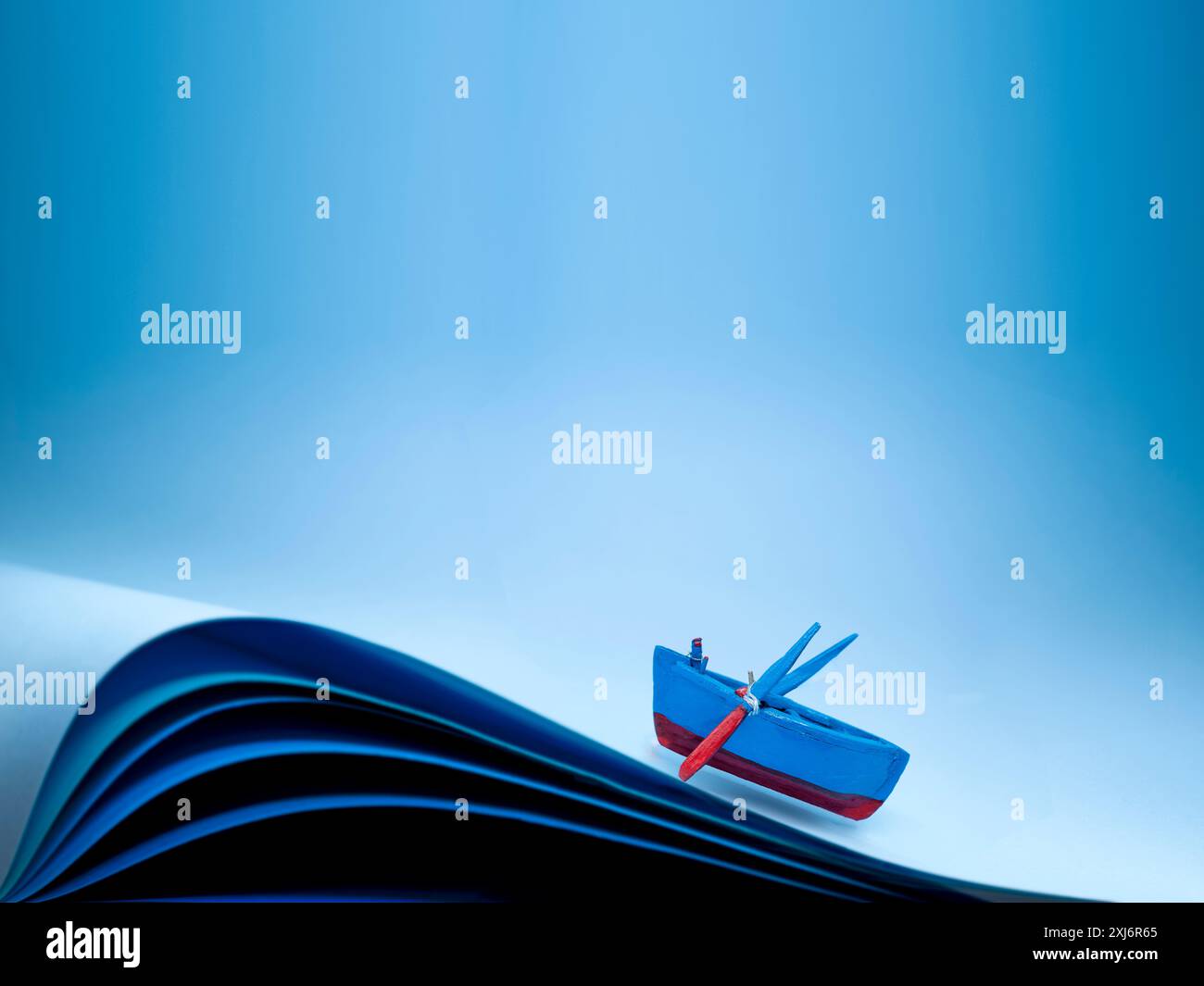 Conceptual empty rowing boat sailing in rough seas Stock Photo - Alamy