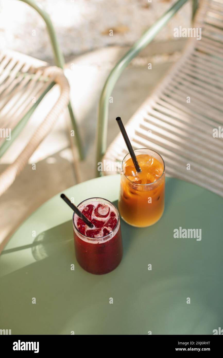 Overhead view of an iced bumble coffee and fruit lemonade drink on a ...