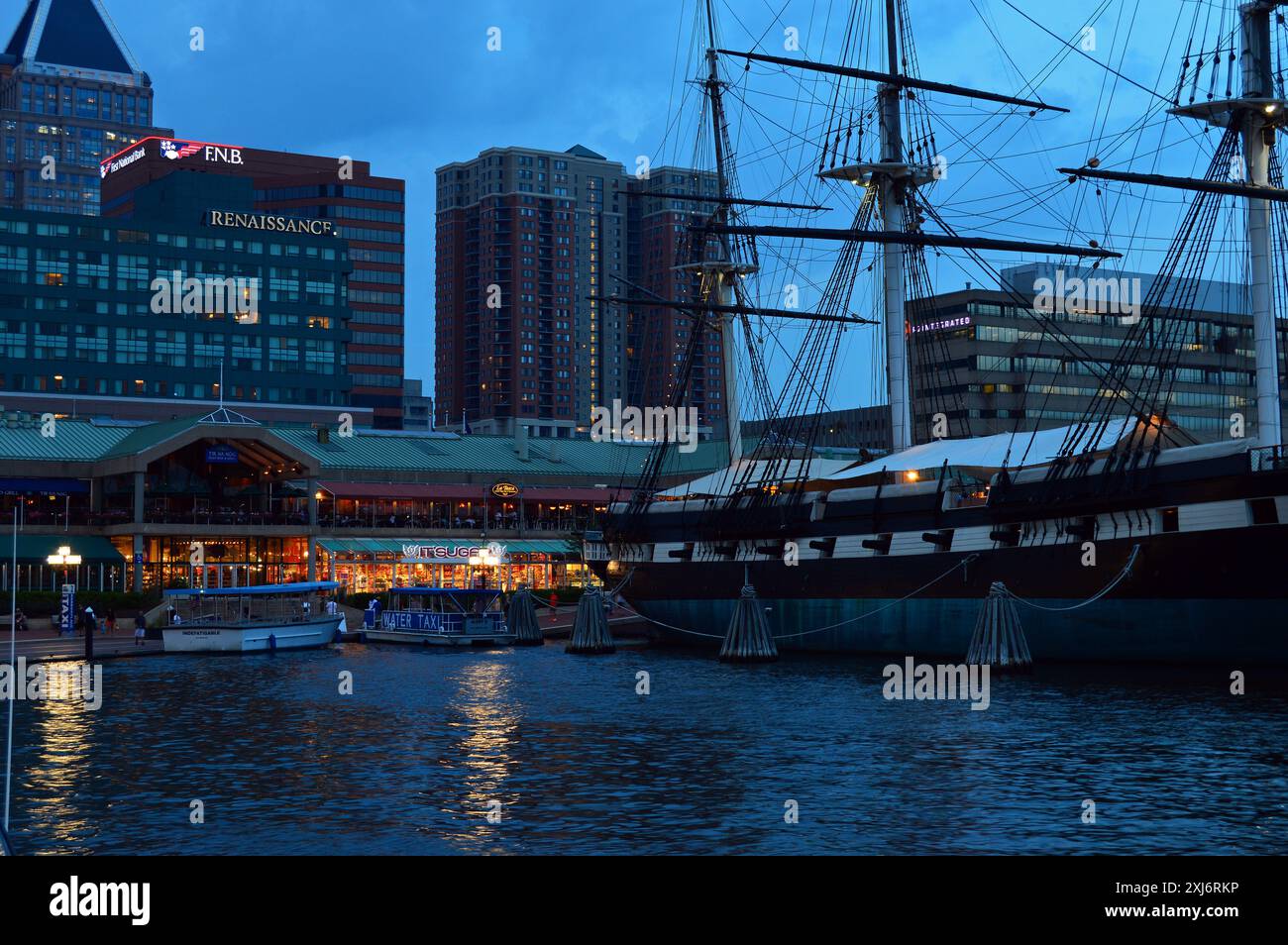 The USS Constellation is moored at Inner Harbor in Baltimore at dusk ...
