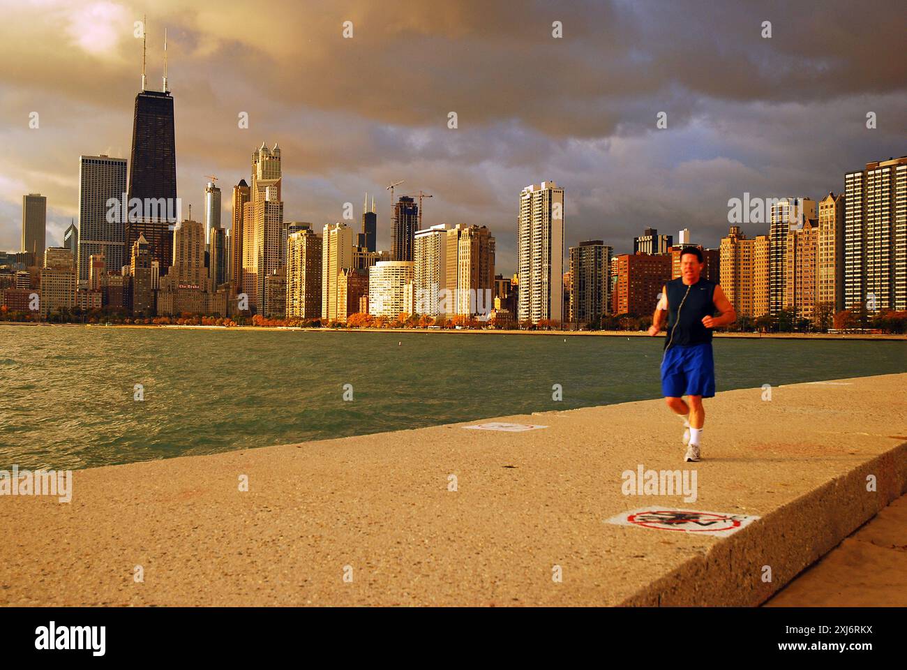 An adult man maintains his healthy lifestyle along the lakeshore in ...