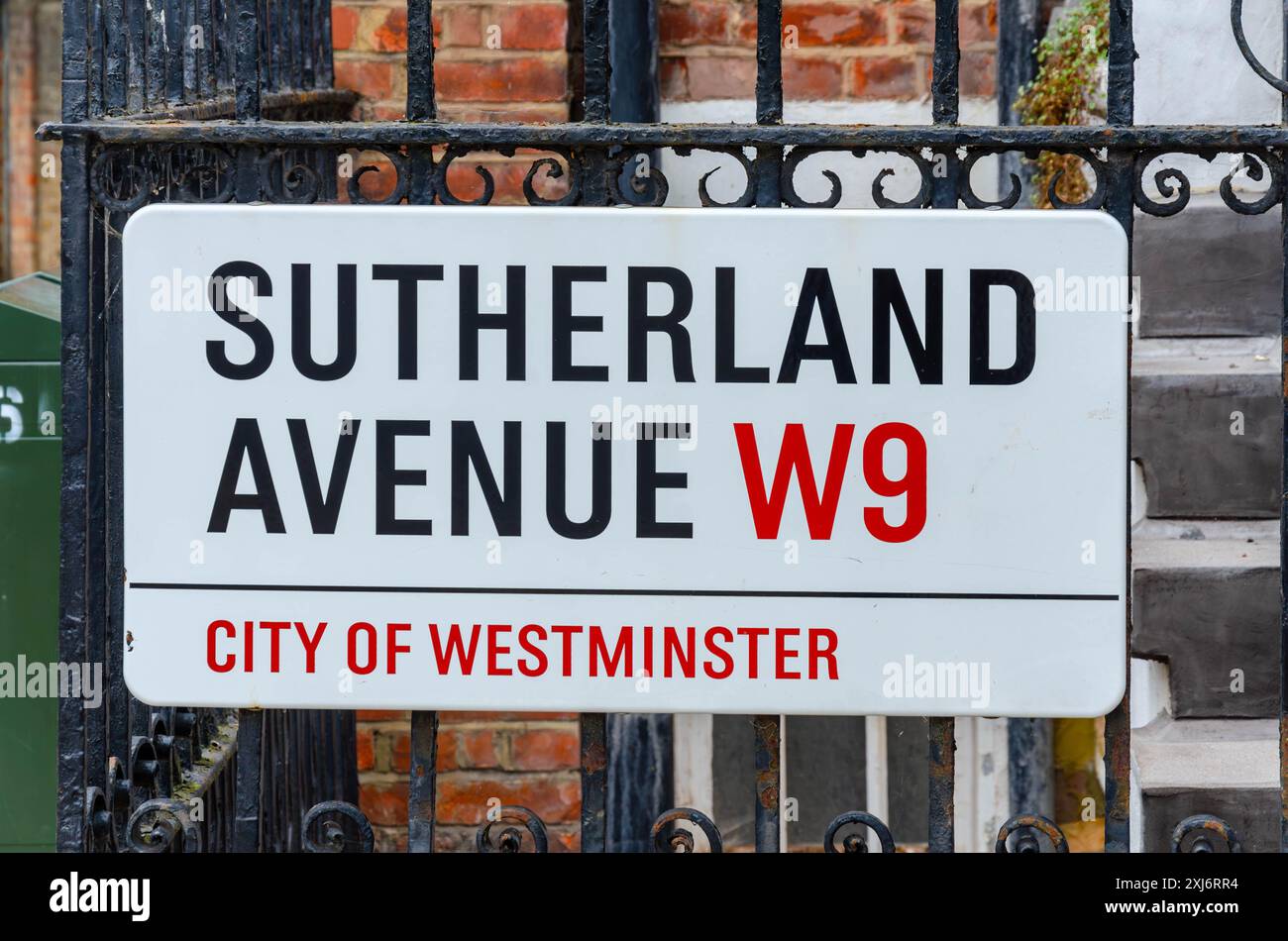 Sutherland Avenue street name sign mounted on a black iron railings in ...