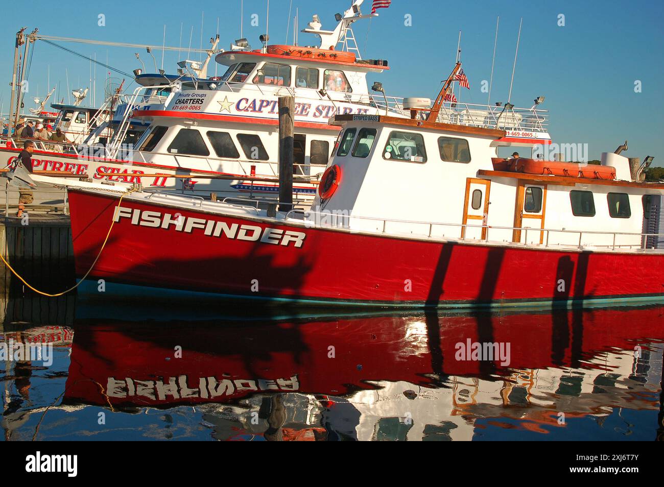Charter fishing boats are moored at a commercial dock Stock Photo - Alamy