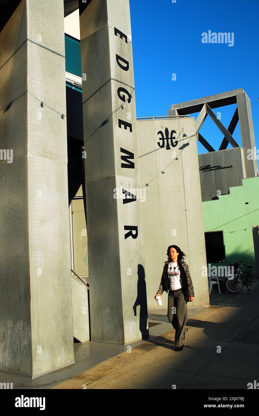 A young woman walks through the Edgemar Shopping Center, designed by ...