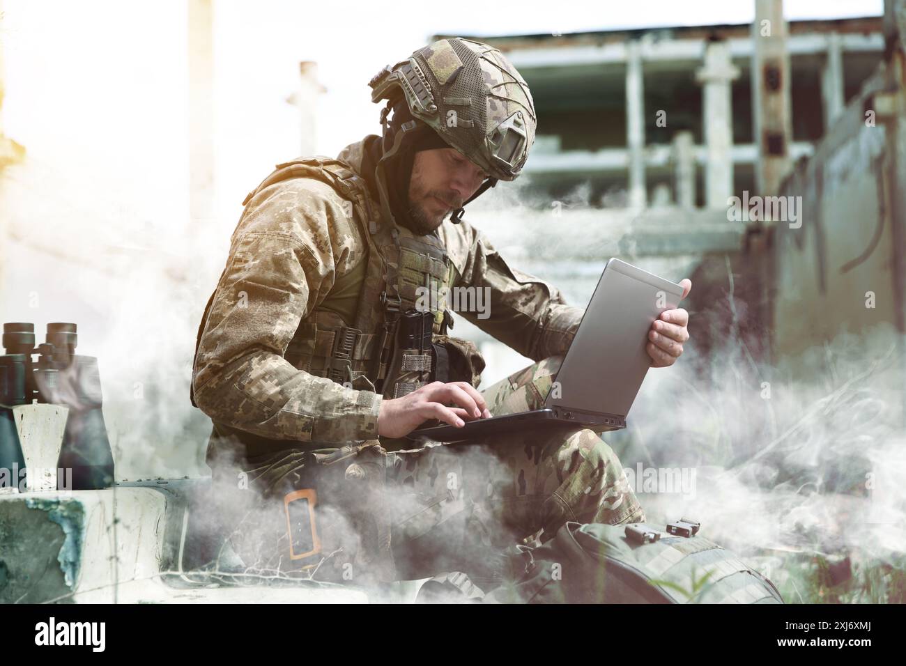 Soldier using laptop near building during military operation Stock ...