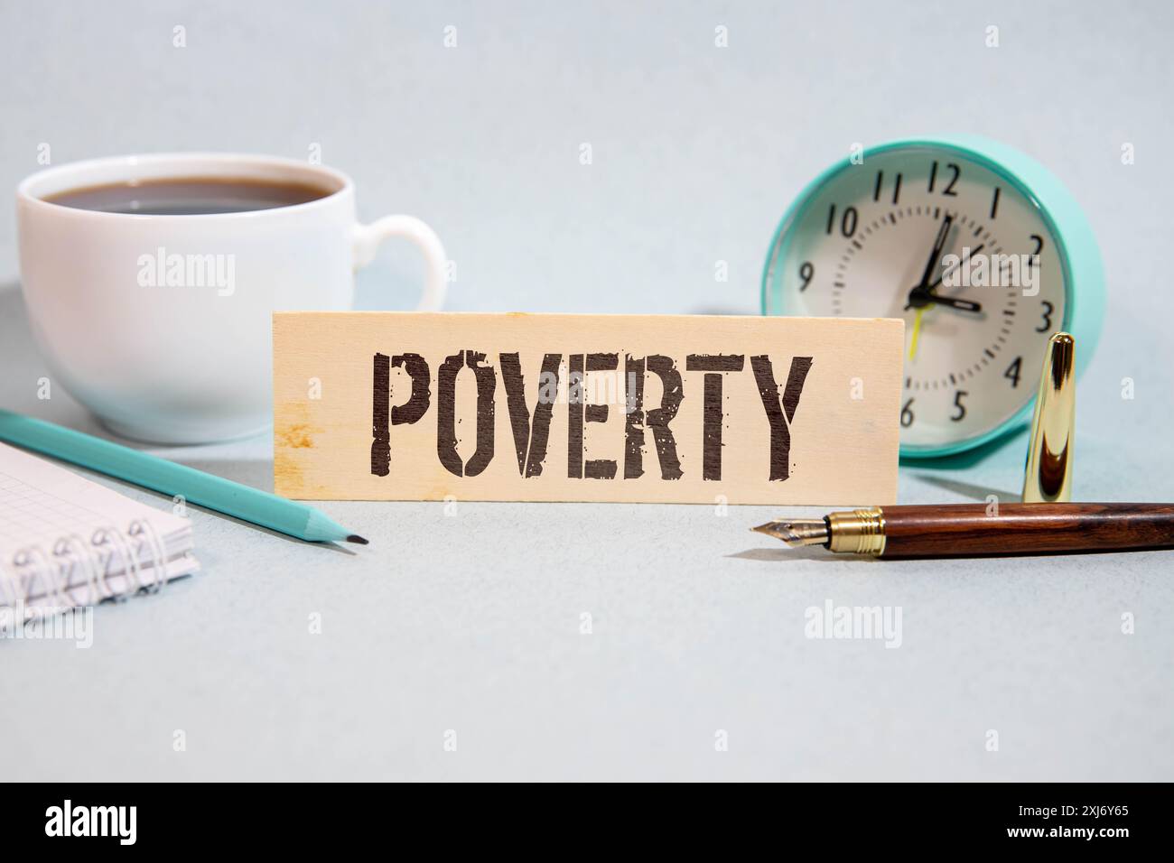 Poverty word written on wood block. Poverty text on cement table for ...