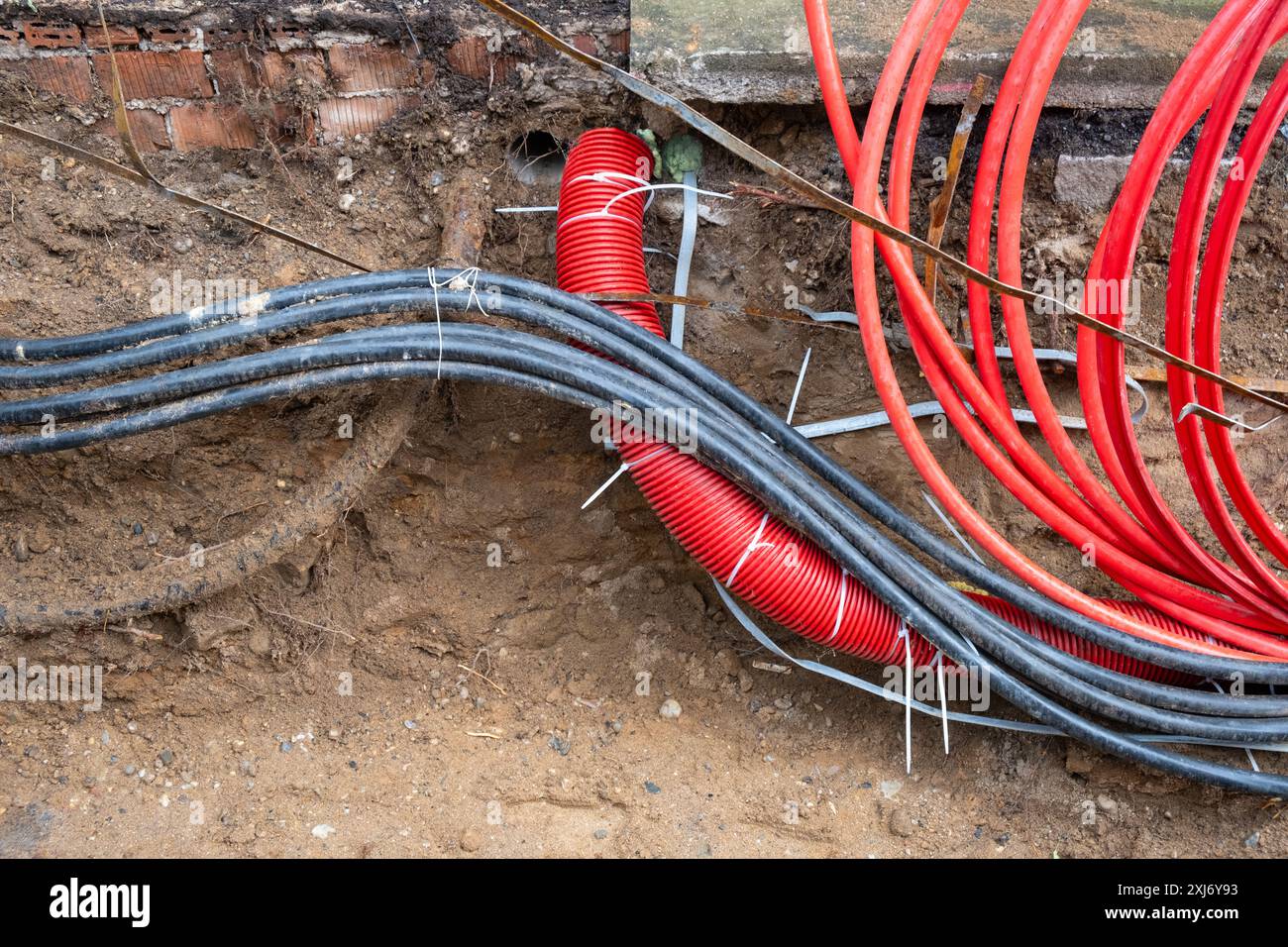 electric and high-speed Internet Network cables in red corrugated pipe ...