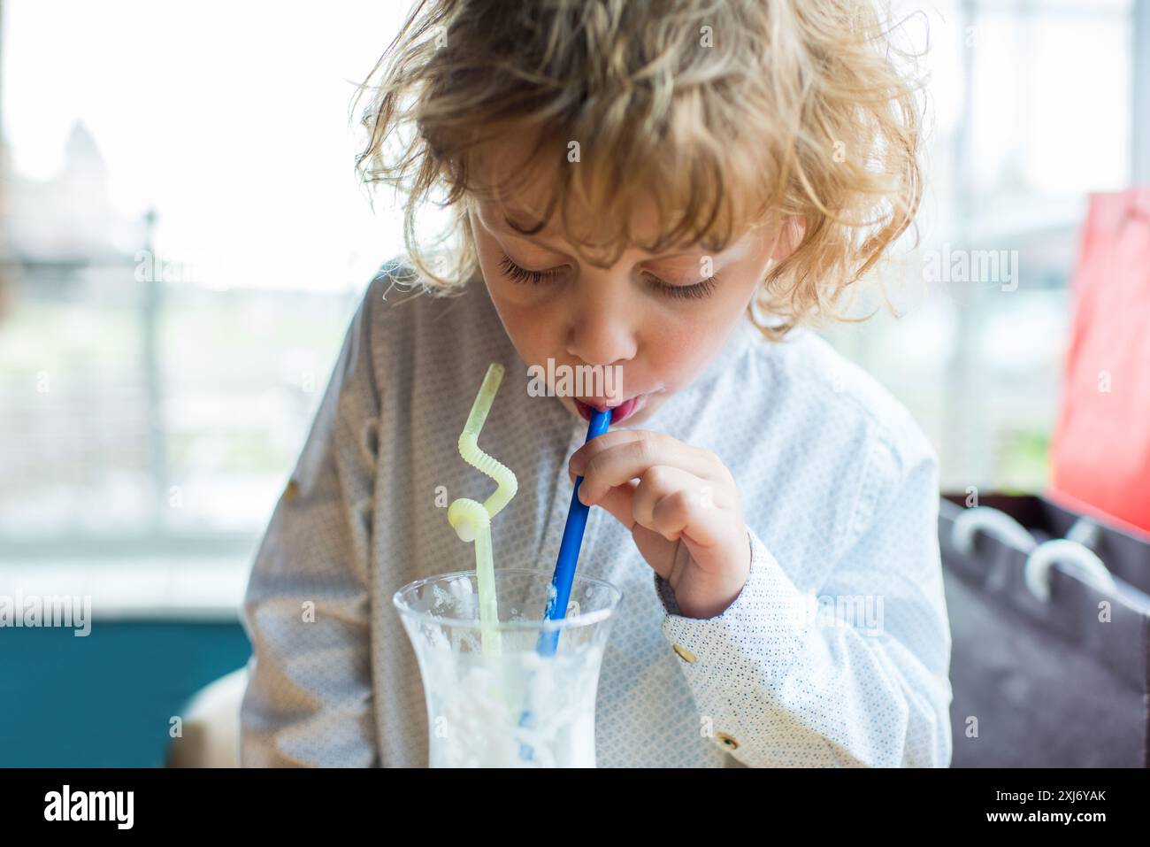 Boy drinking milkshake Stock Photo - Alamy