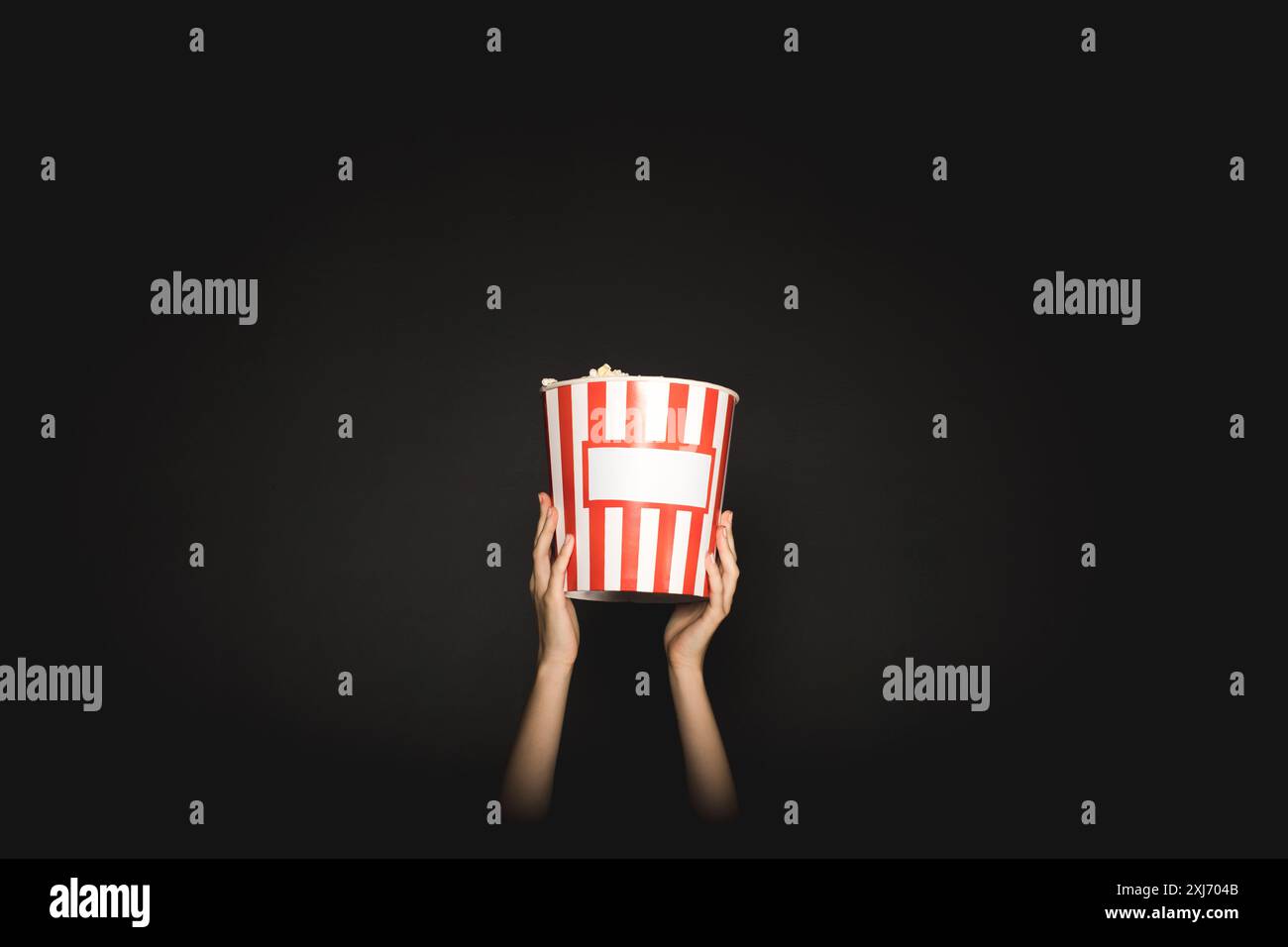 Woman holding bucket popcorn hi-res stock photography and images - Alamy