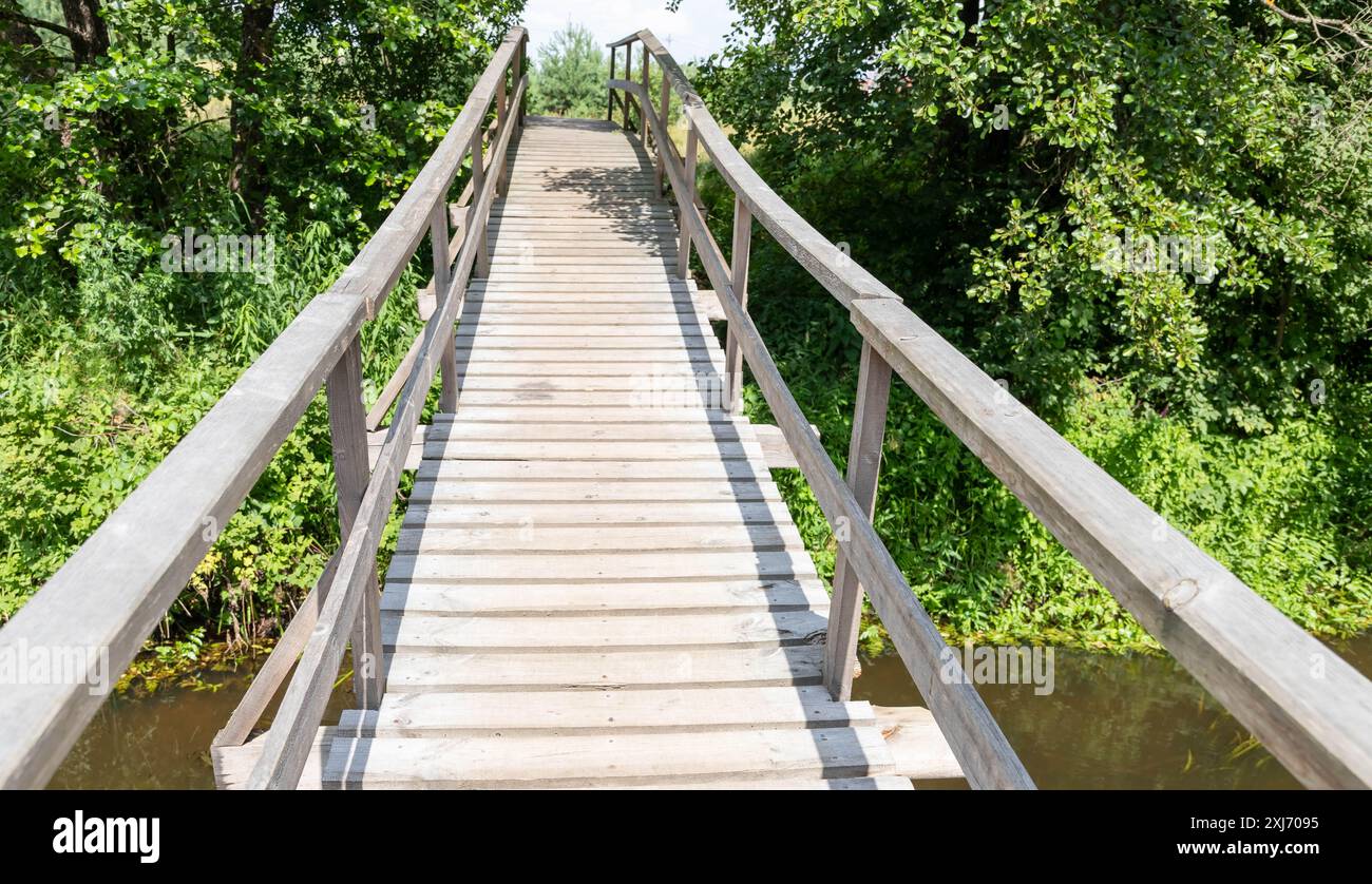 Old pedestrian suspension bridge over water Stock Photo - Alamy