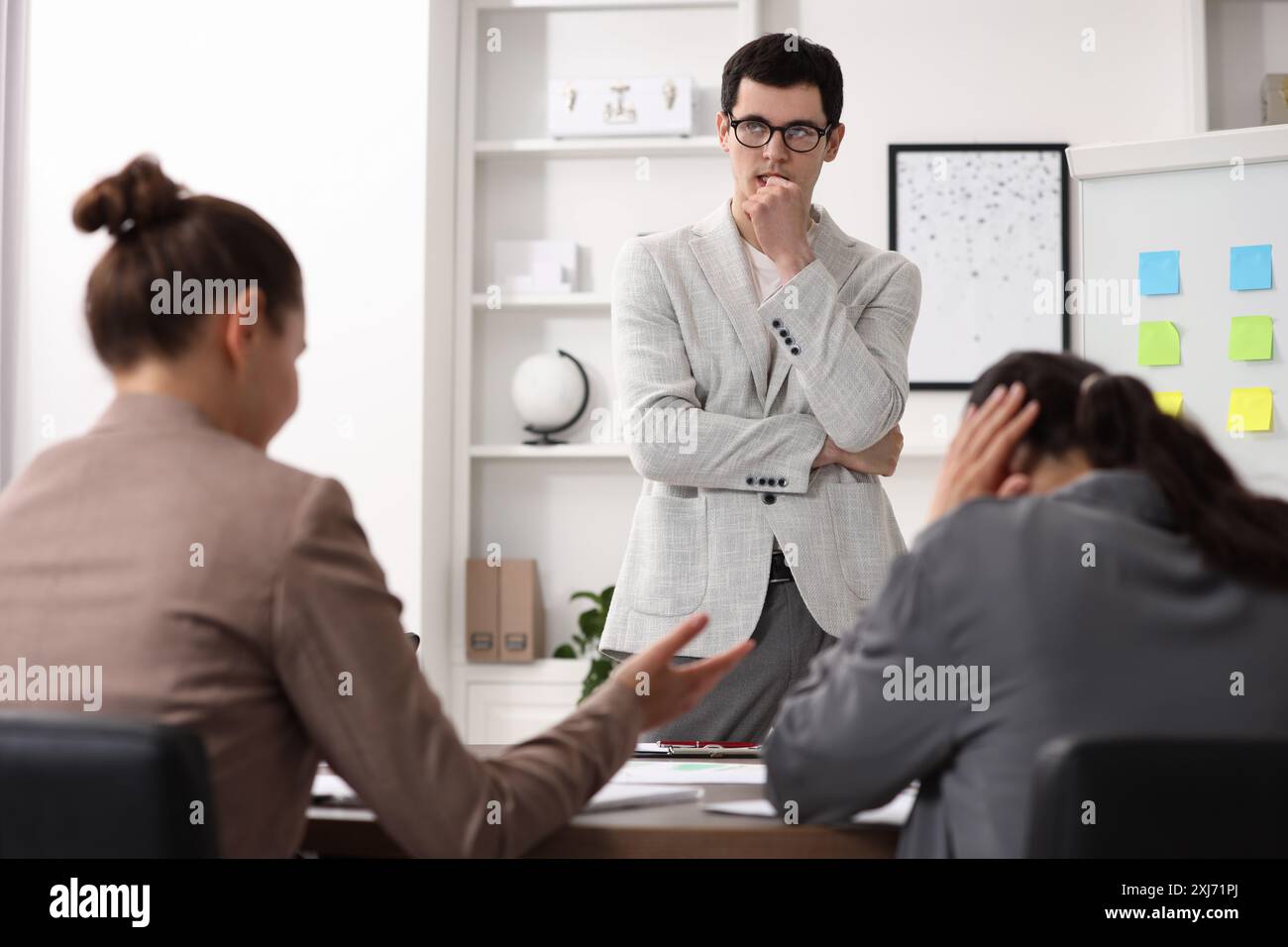 Man feeling embarrassed during business meeting in office Stock Photo ...