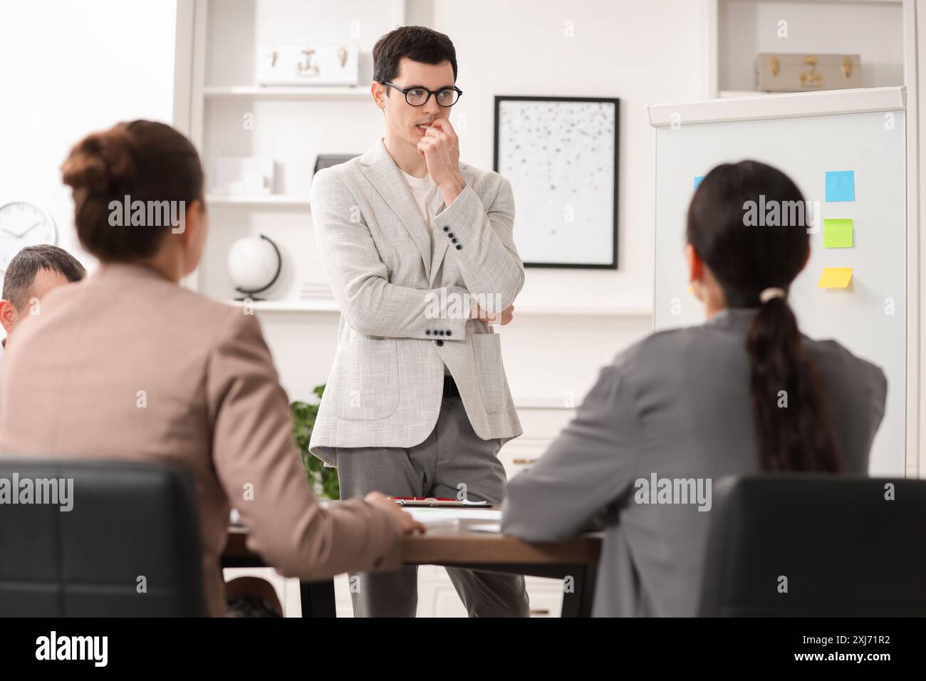 Man feeling embarrassed during business meeting in office Stock Photo ...