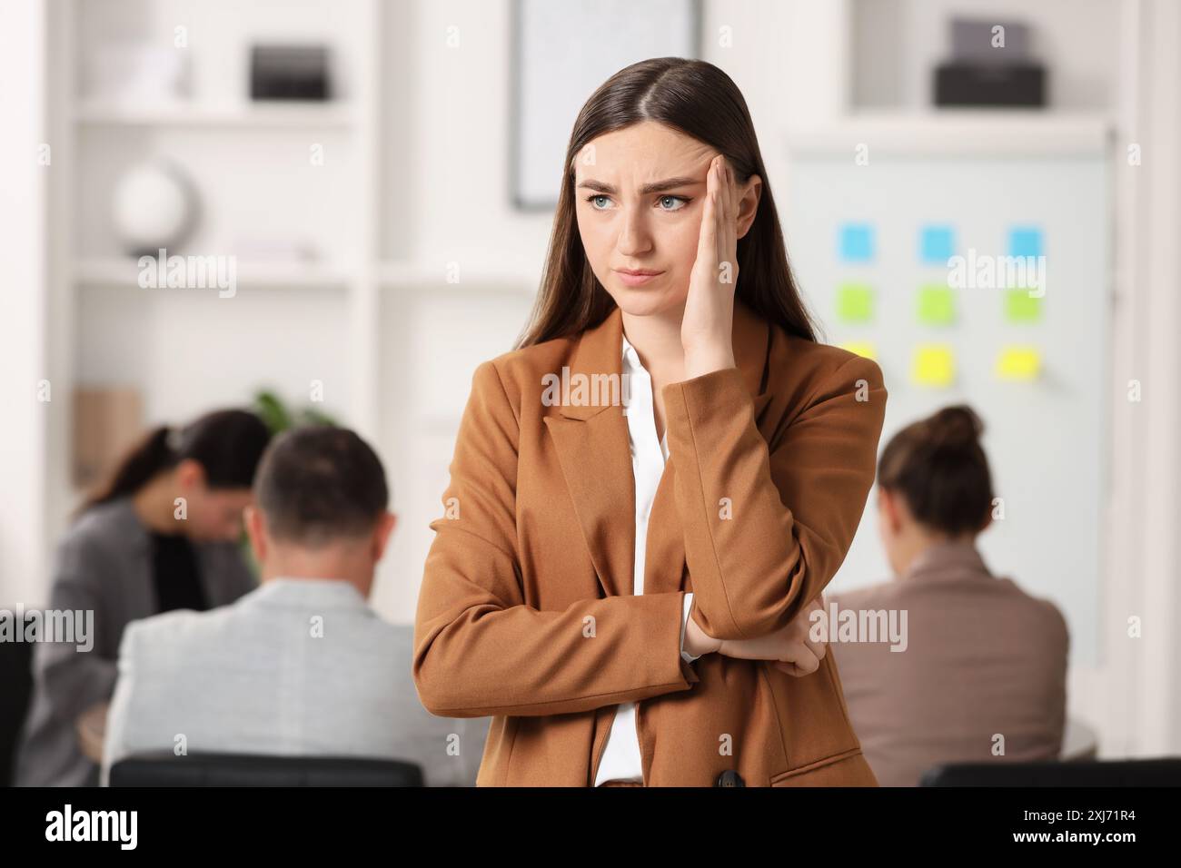 Woman feeling embarrassed during business meeting in office Stock Photo ...