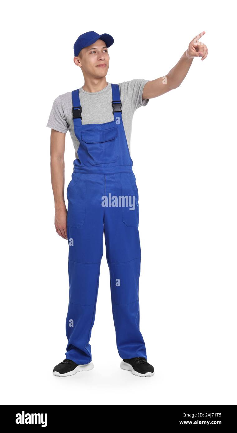 Auto mechanic pointing at something on white background Stock Photo - Alamy