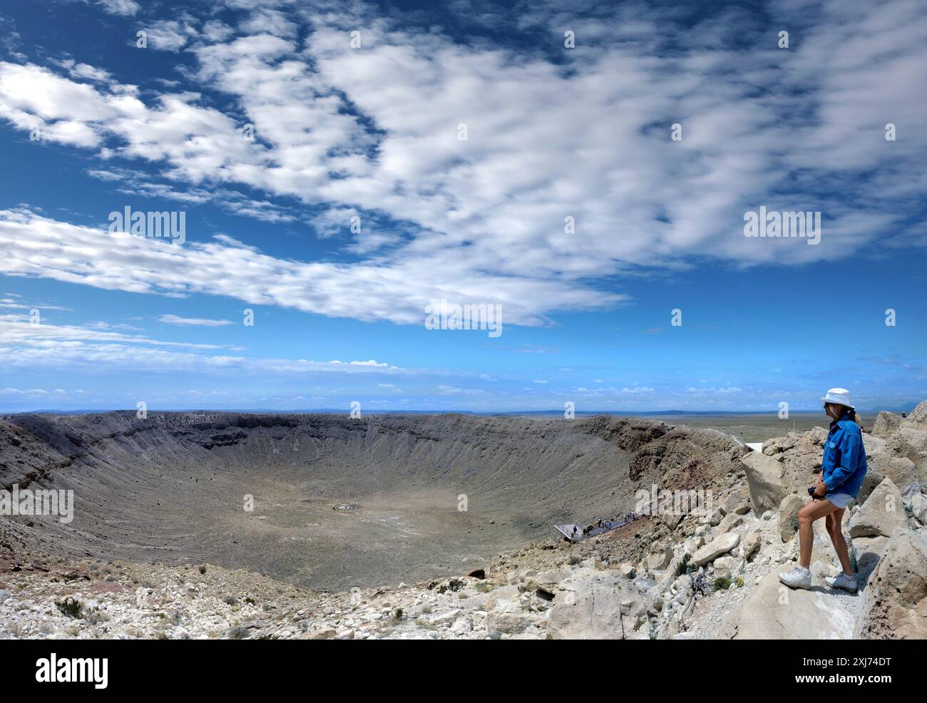 Tourist at a meteorite crater in Arizona, USA. This crater, known as ...