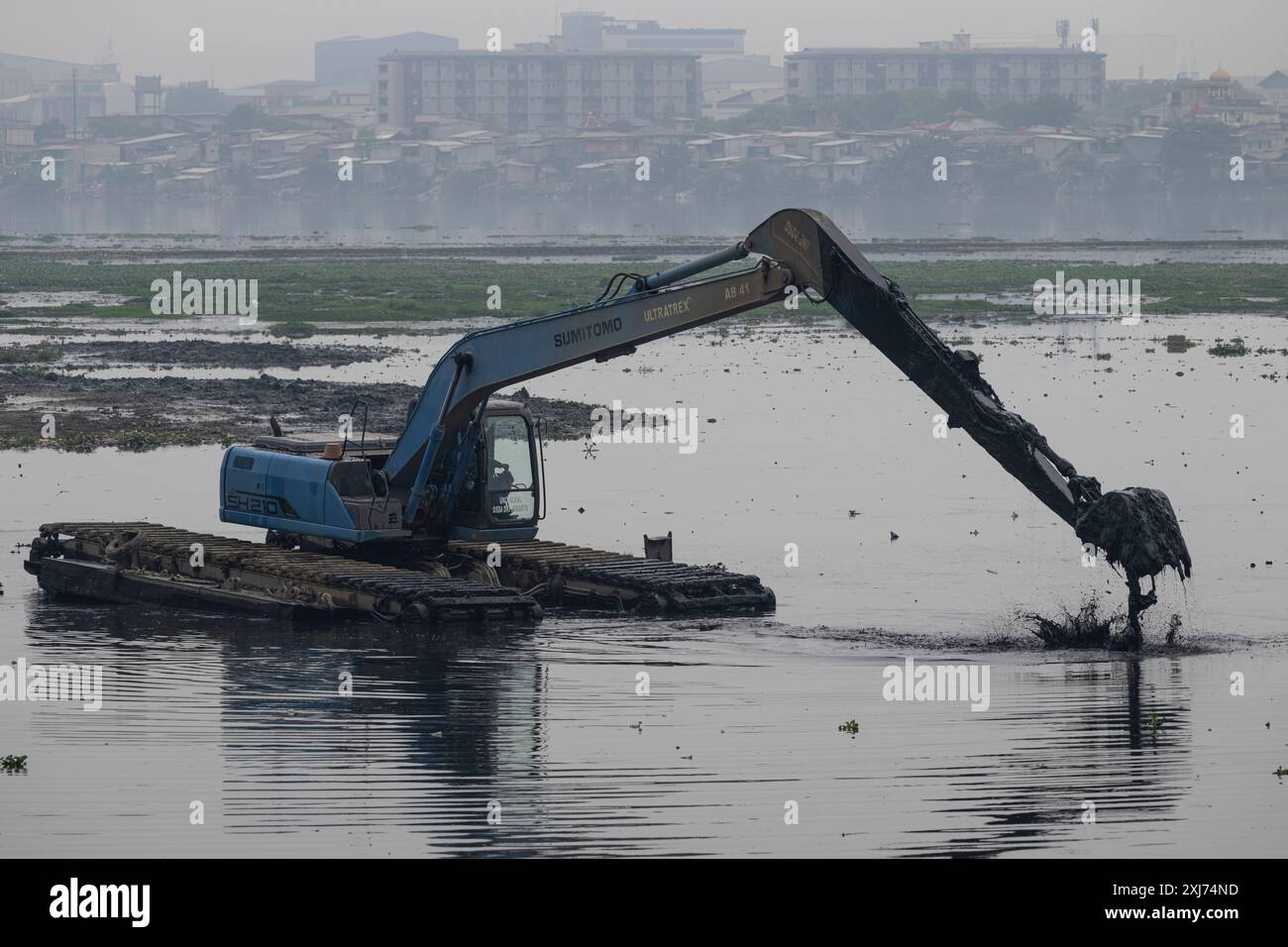 Editorial use only Dredging machine operating in the Waduk (Lake) Pluit ...