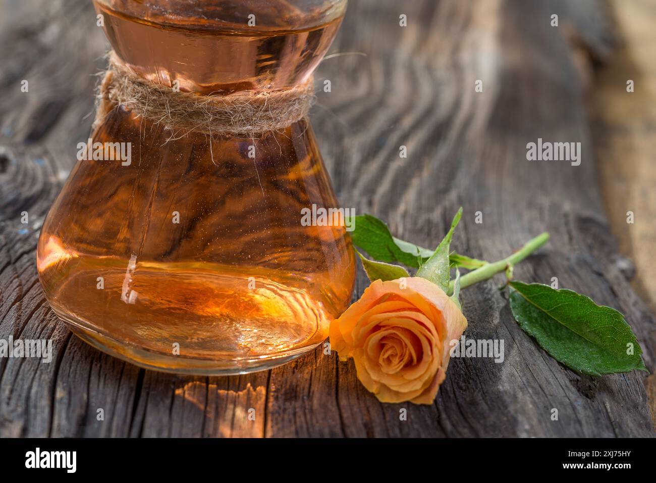 Orange-colored rose essential oil Stock Photo - Alamy
