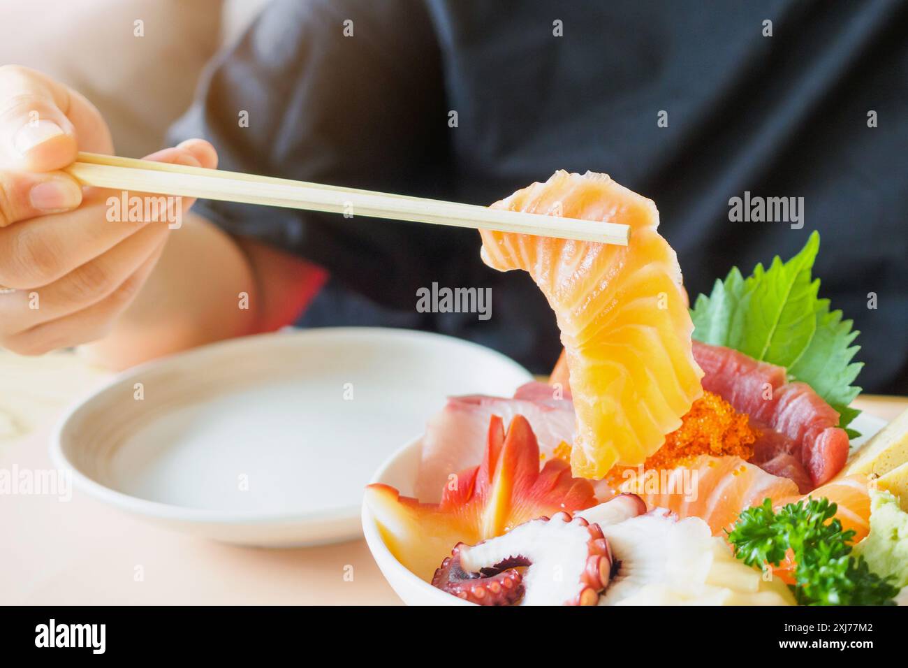 Salmon slice in chopsticks, Eating Sashimi Rice Bowl Chirashi Don ...