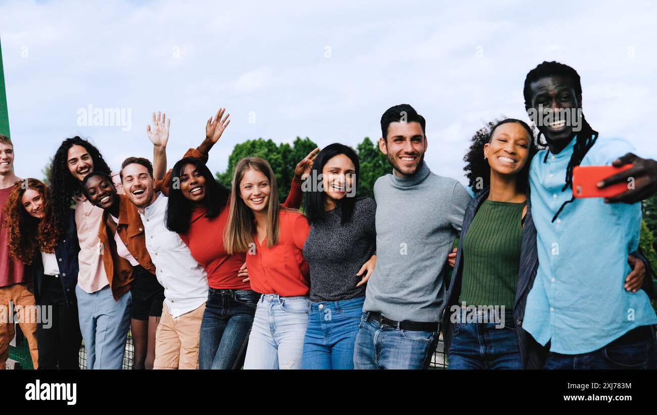Diverse group of people taking selfie photo smiling at phone camera ...