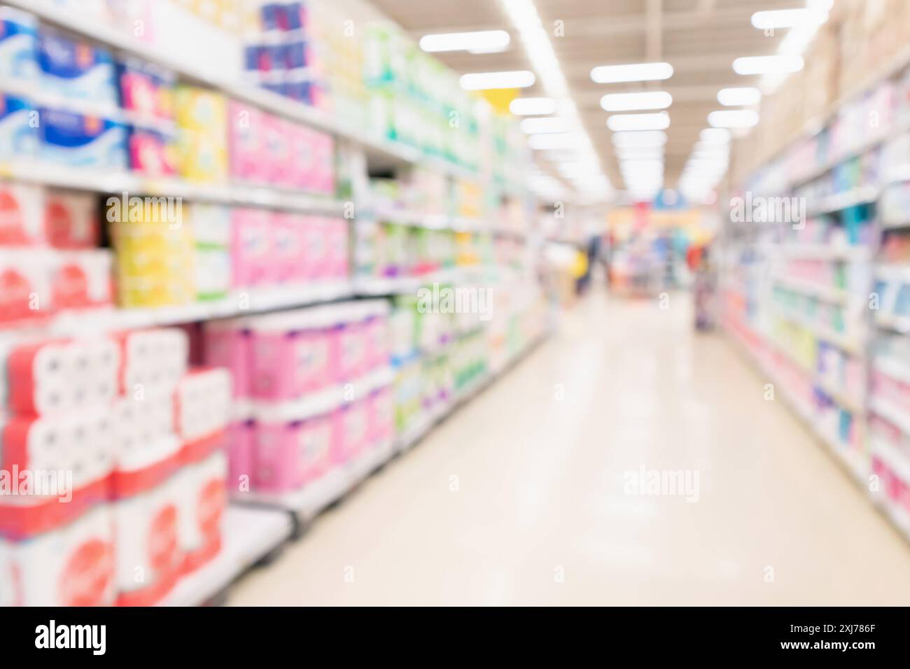 Abstract blurred supermarket aisle and shelves with various toilet ...
