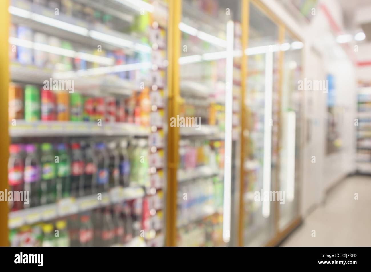 Beverage soft drink bottles in convenience store refrigerator shelves ...