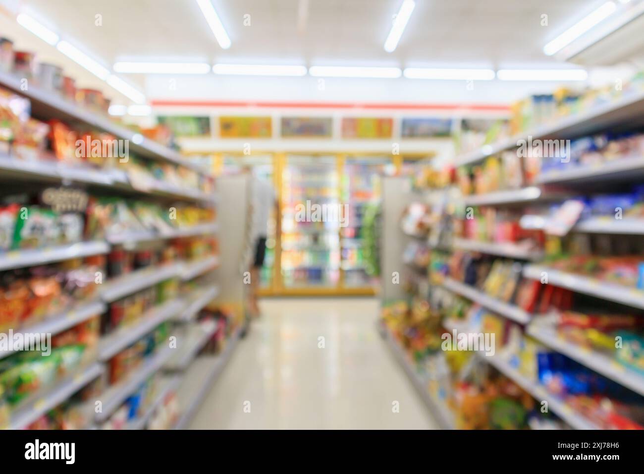Supermarket convenience store aisle shelves interior blur for background Stock Photo - Alamy