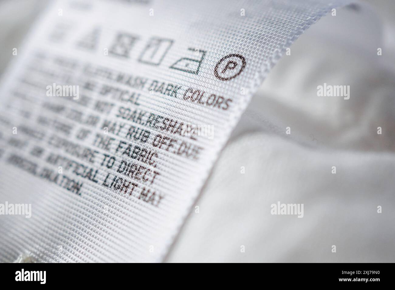 Cloth label tag with laundry care instructions Stock Photo - Alamy
