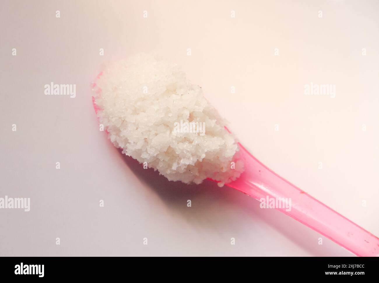 One spoonful of salt on a white background Stock Photo - Alamy