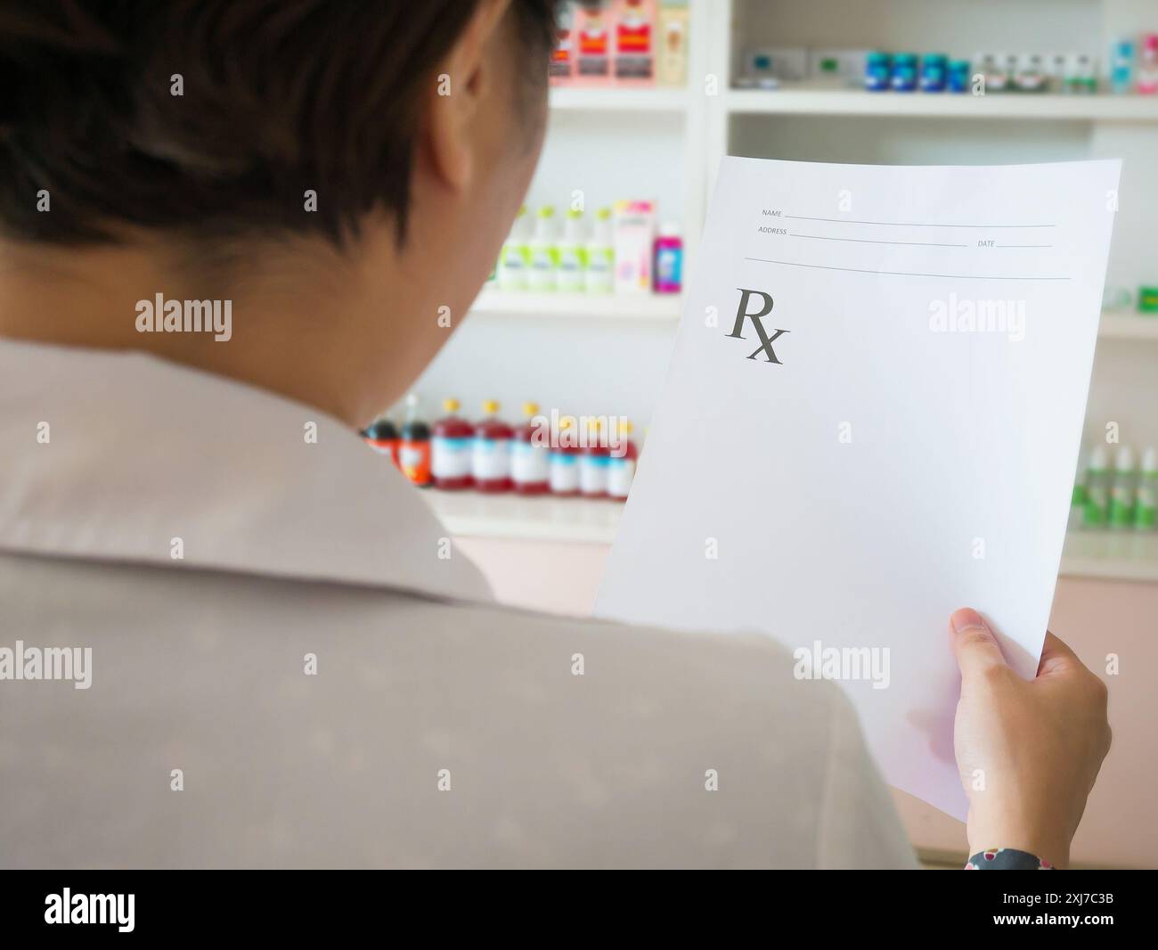 asian female pharmacist reading prescription at the pharmacy Stock ...