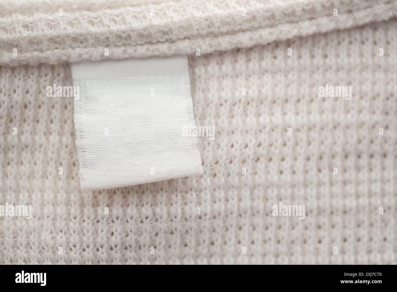 White blank clothing label on cotton shirt background Stock Photo - Alamy