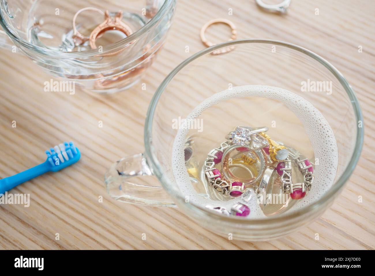 cleaning jewelry diamond ring with glass of hot water and dishwashing ...