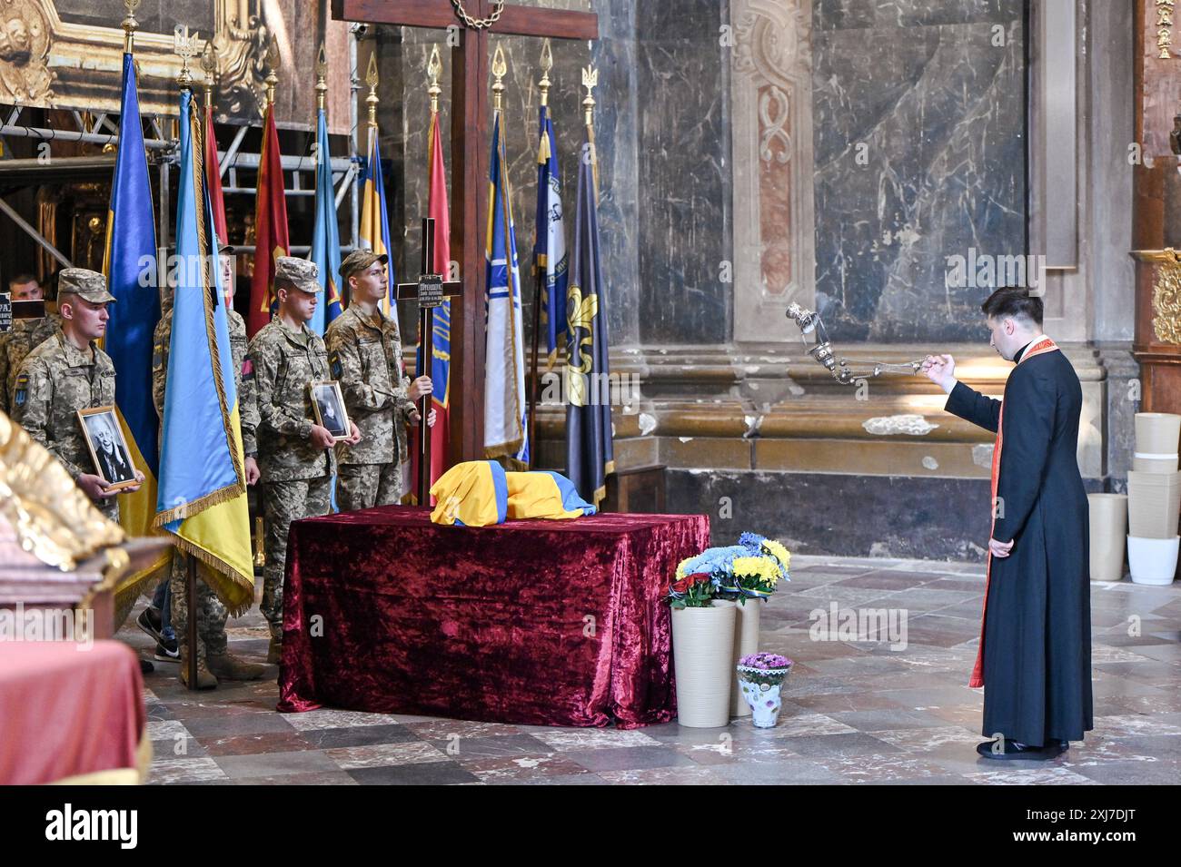 Non Exclusive: LVIV, UKRAINE - JULY 13, 2024 - A priest swings a censer ...