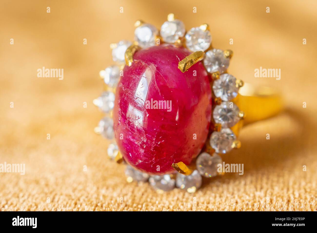 Jewelry red ruby ring on golden fabric background close up Stock Photo ...