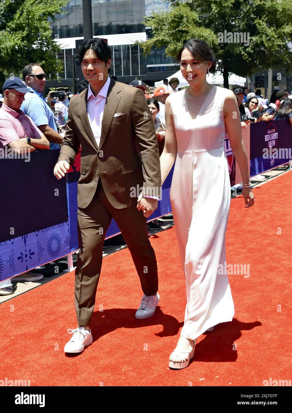 Los Angeles Dodgers' Shohei Ohtani walks with his wife Mamiko during ...