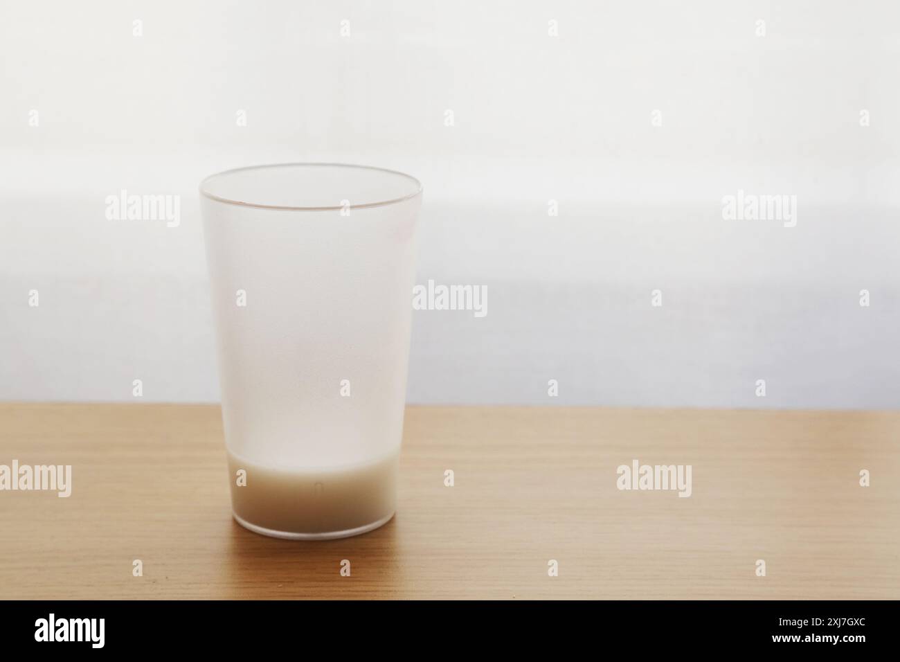 A frosted glass of milk opposite the window Stock Photo - Alamy
