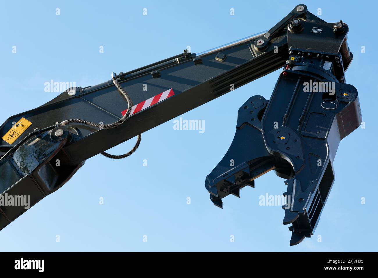 Excavator arm with rotating crusher attachment. Selective focus Stock ...
