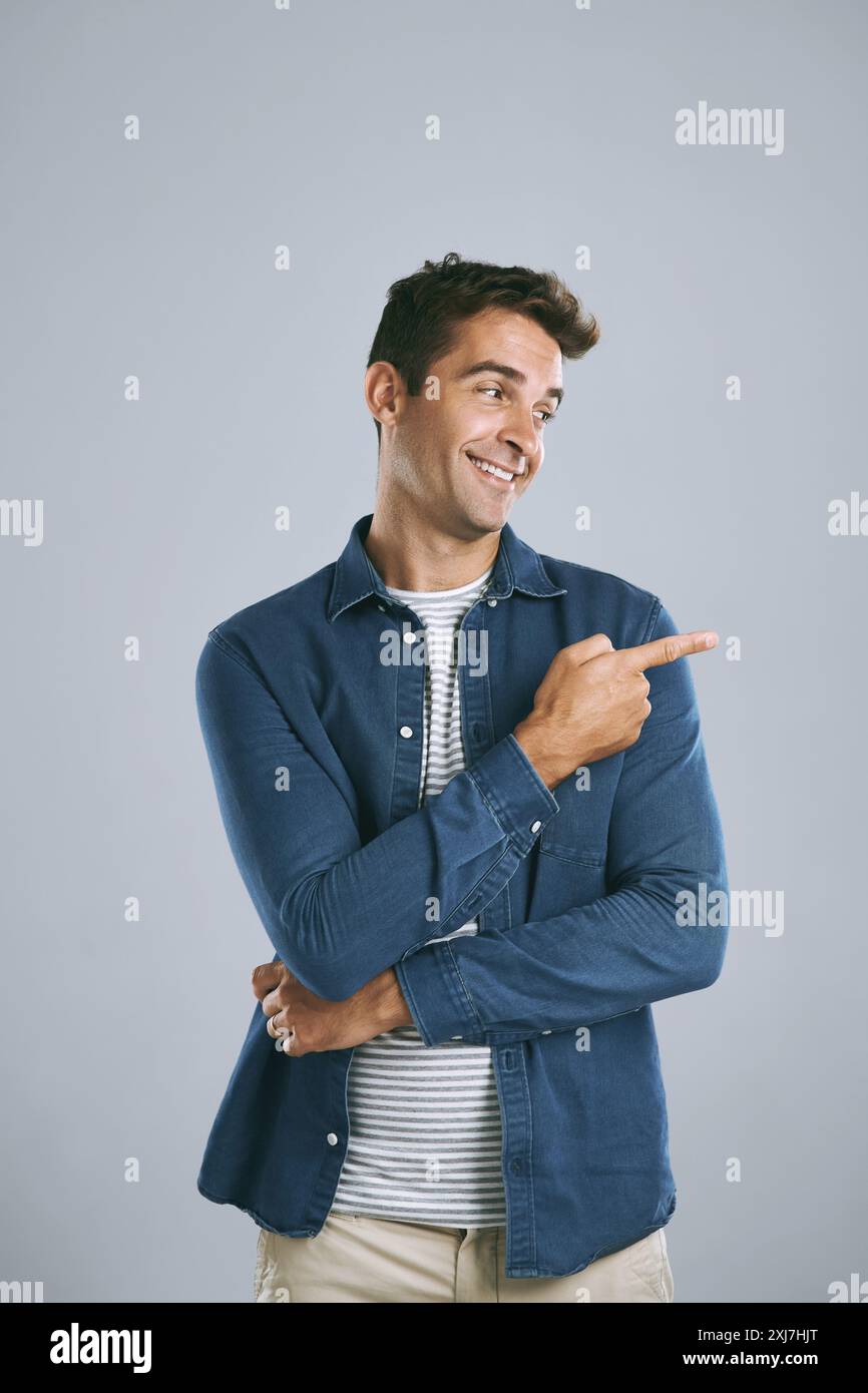 Portrait, pointing and man with review, promotion and model on grey ...
