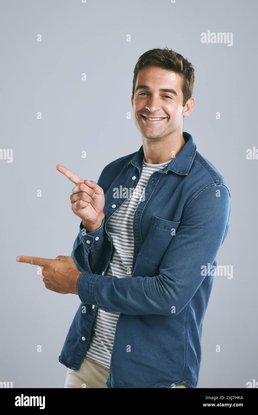 Portrait, pointing and man with review, menu and information on grey ...