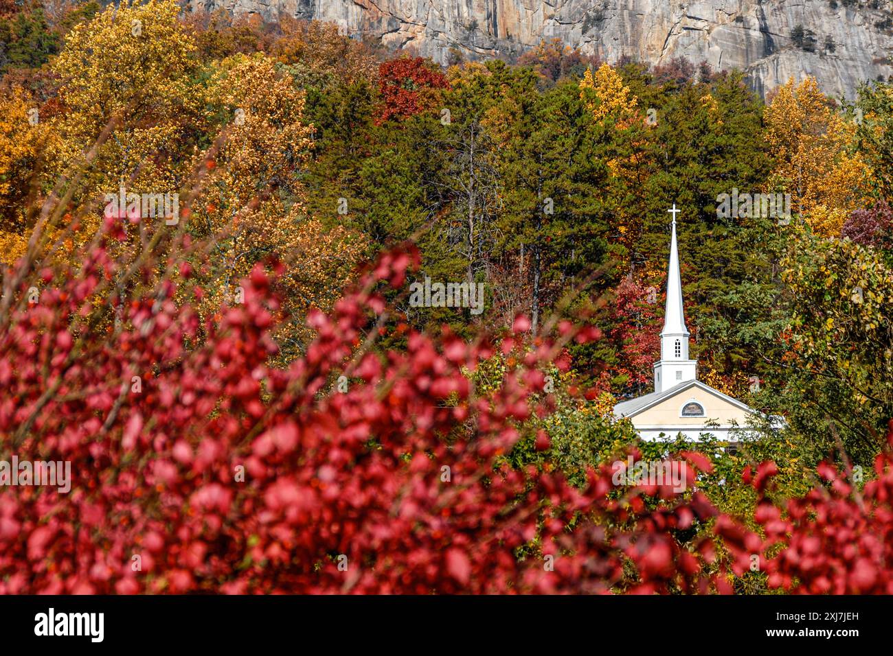 Chimney Rock Baptist Church with white steeple amidst fall foliage in ...