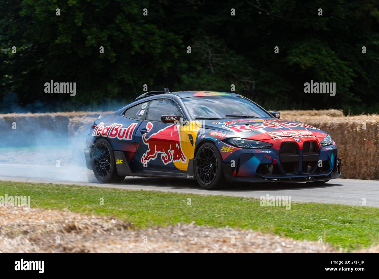 2024 BMW M4 G82 drift car driving up the hill climb track at the Goodwood Festival of Speed 2024 ...
