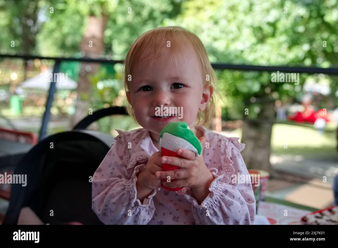 Portrait of little girl holding stuffed toy Stock Photo - Alamy