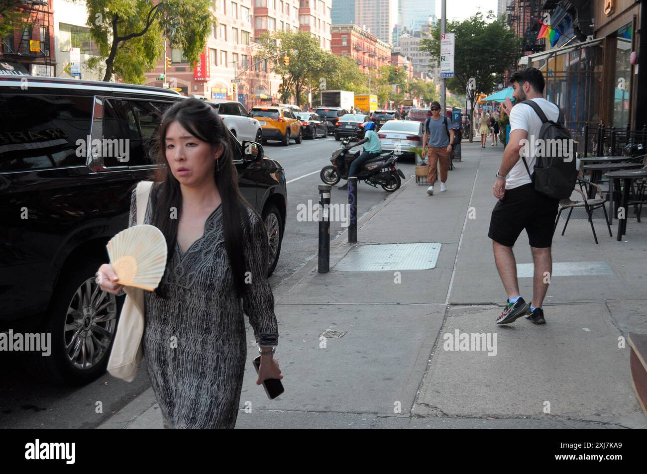 New York, United States. 16th July, 2024. A person, left, uses a fan ...