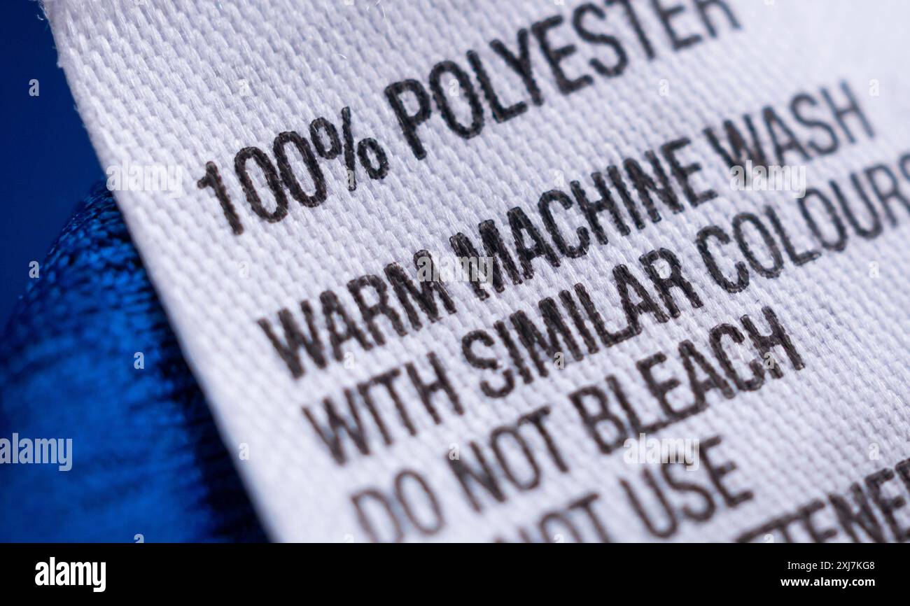 Polyester clothing label with laundry care instructions tag on blue ...