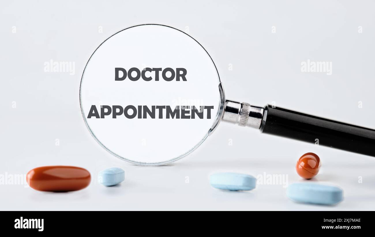 The words DOCTOR APPOINTMENT written through a magnifying glass on a ...