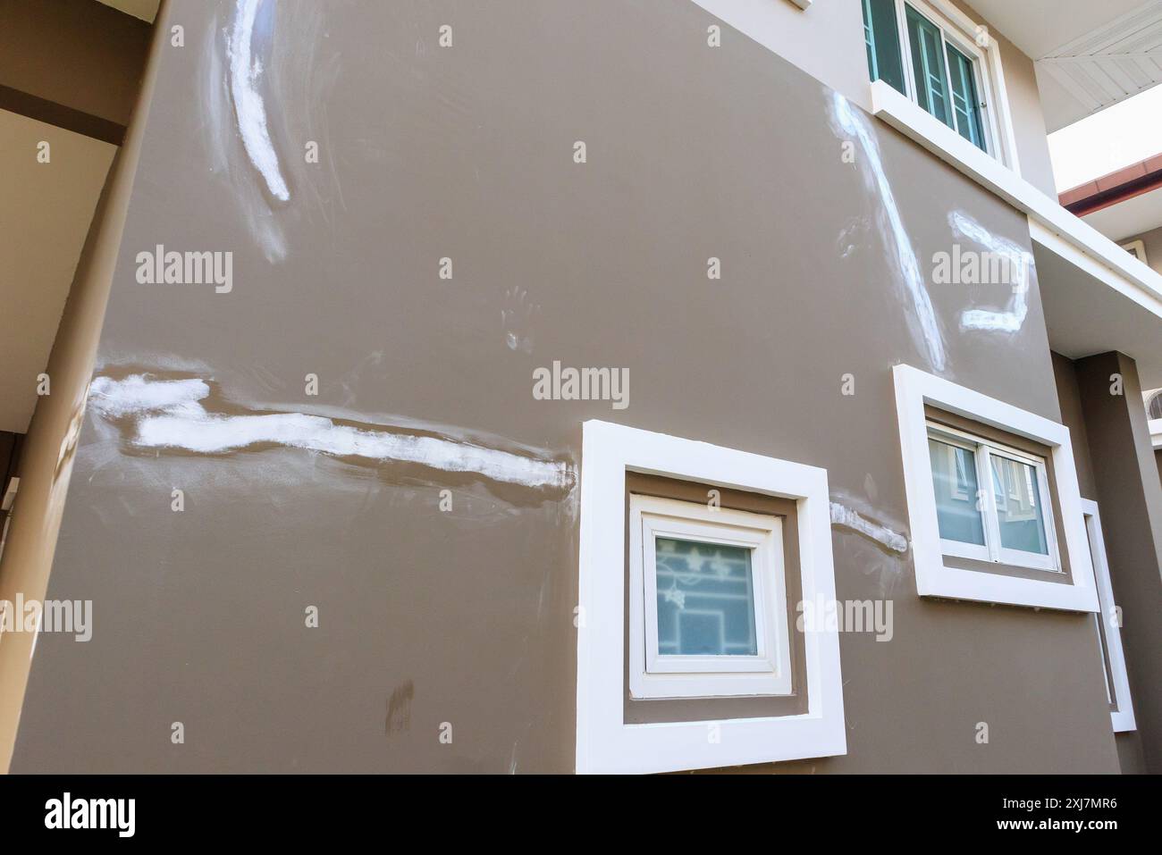 Repair crack on house wall with skim coating plaster Stock Photo - Alamy