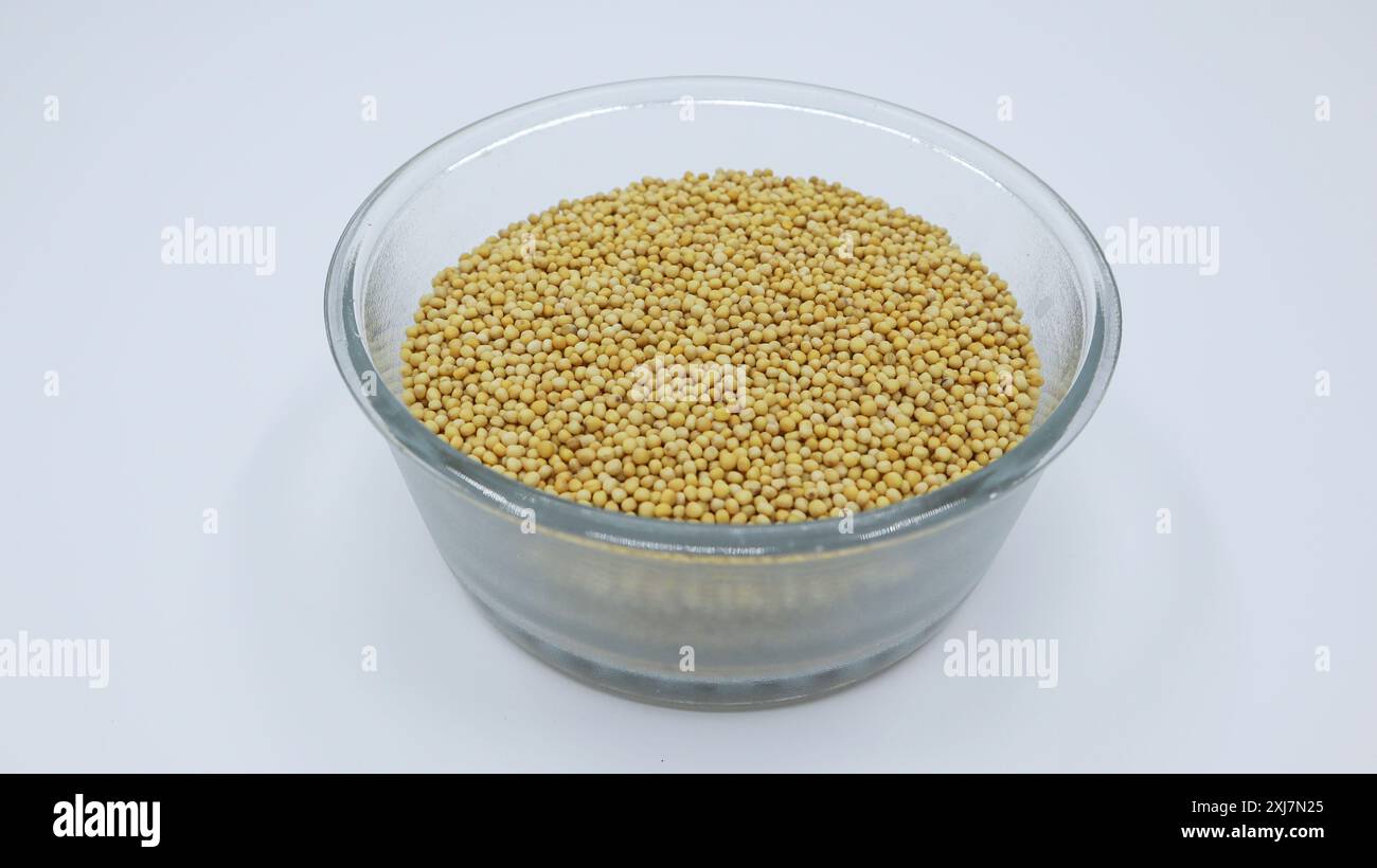 Top view of Yellow mustard seeds in transparent bowl on white ...